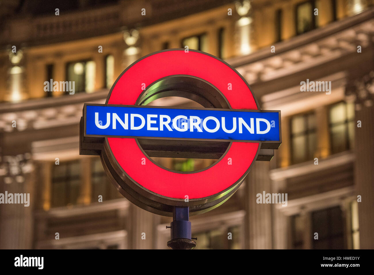 London underground sign at night with a beautiful architecture ...