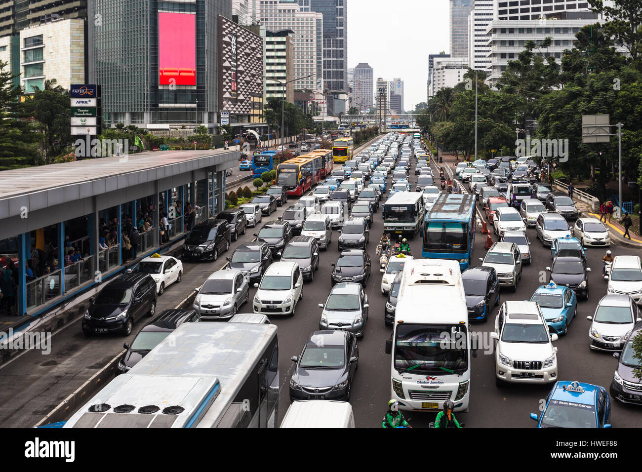 JAKARTA, INDONESIA - JANUARY 27, 2017: Cars, buses and motorcycles try ...