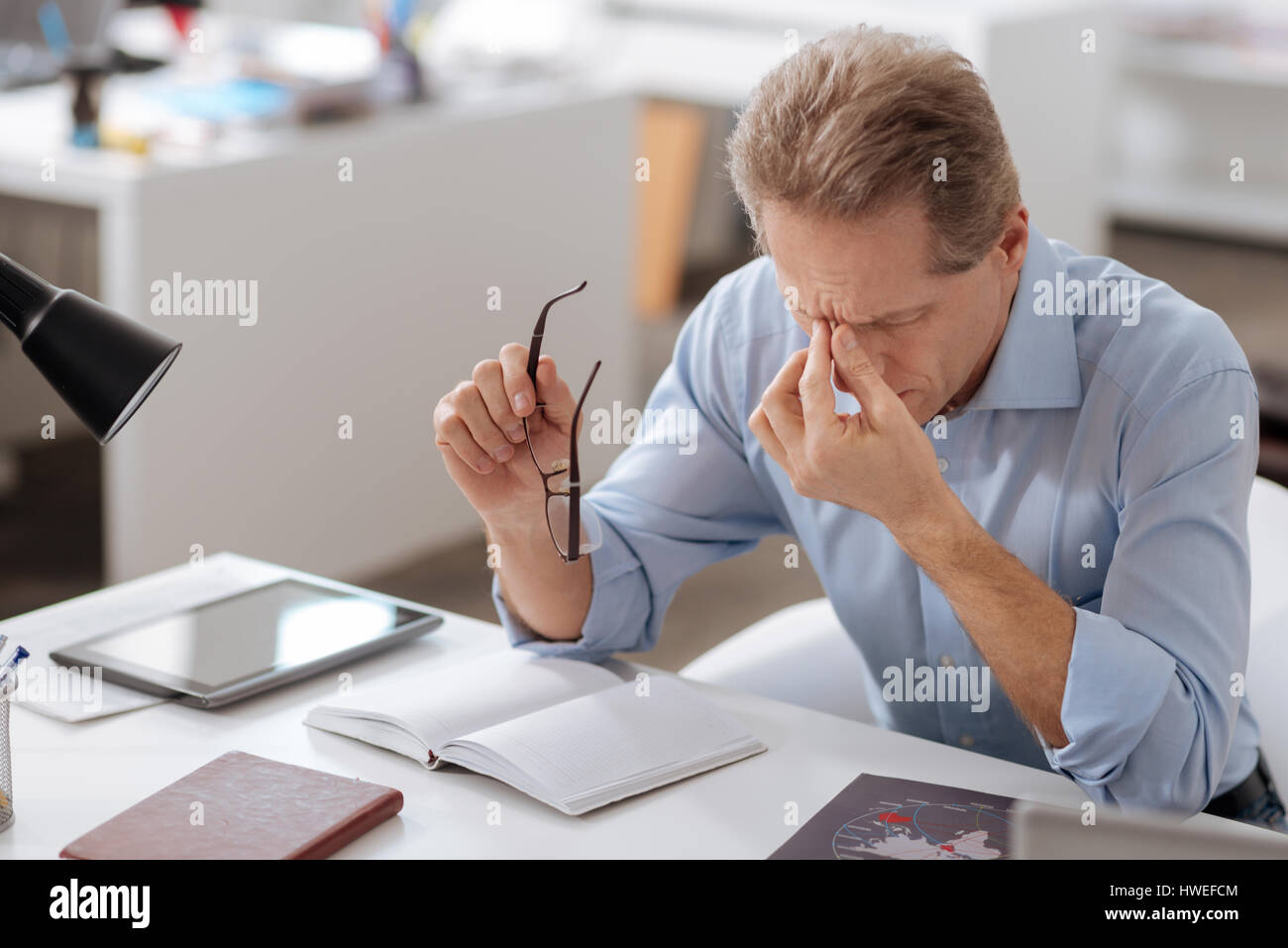 Tired office bowing head hi-res stock photography and images - Alamy