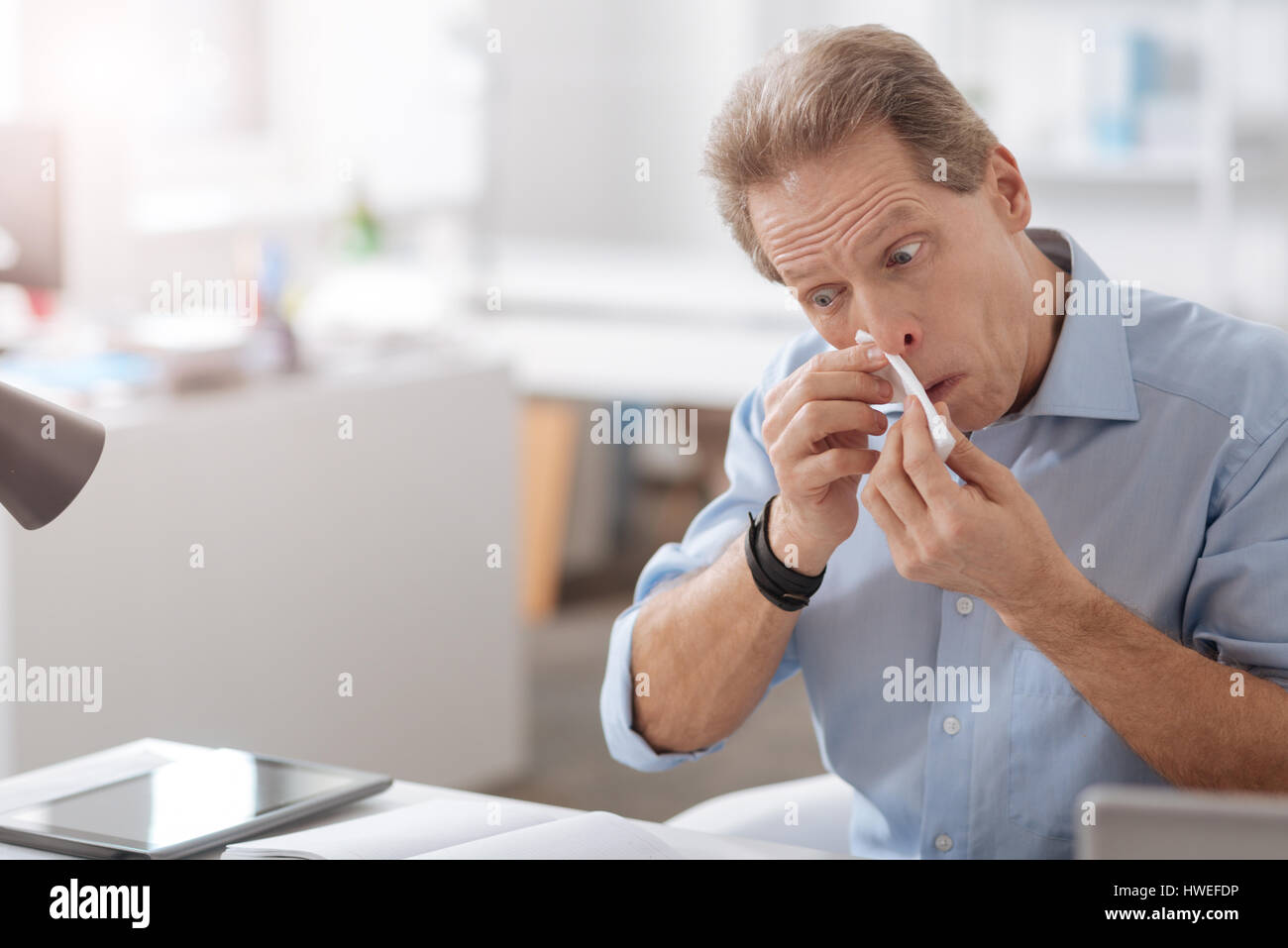 Very attentive male person wiping his nose Stock Photo - Alamy