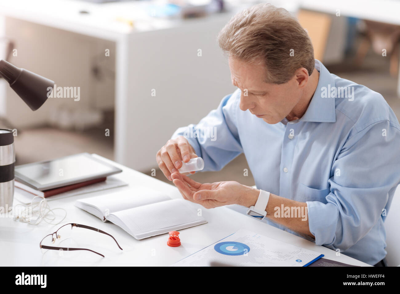 Serious man taking useful tablet Stock Photo - Alamy