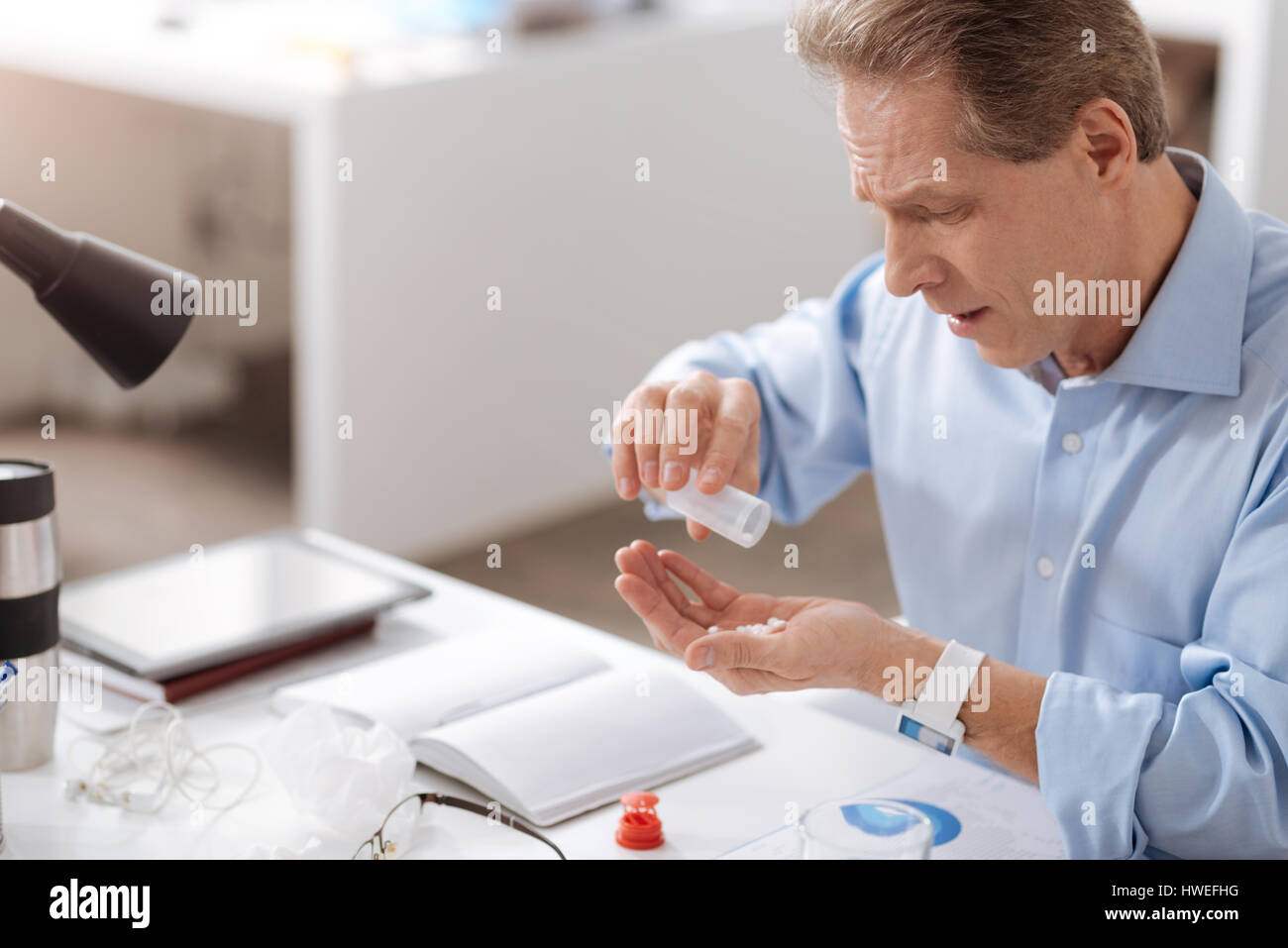 Attentive male person sitting in semi position Stock Photo - Alamy