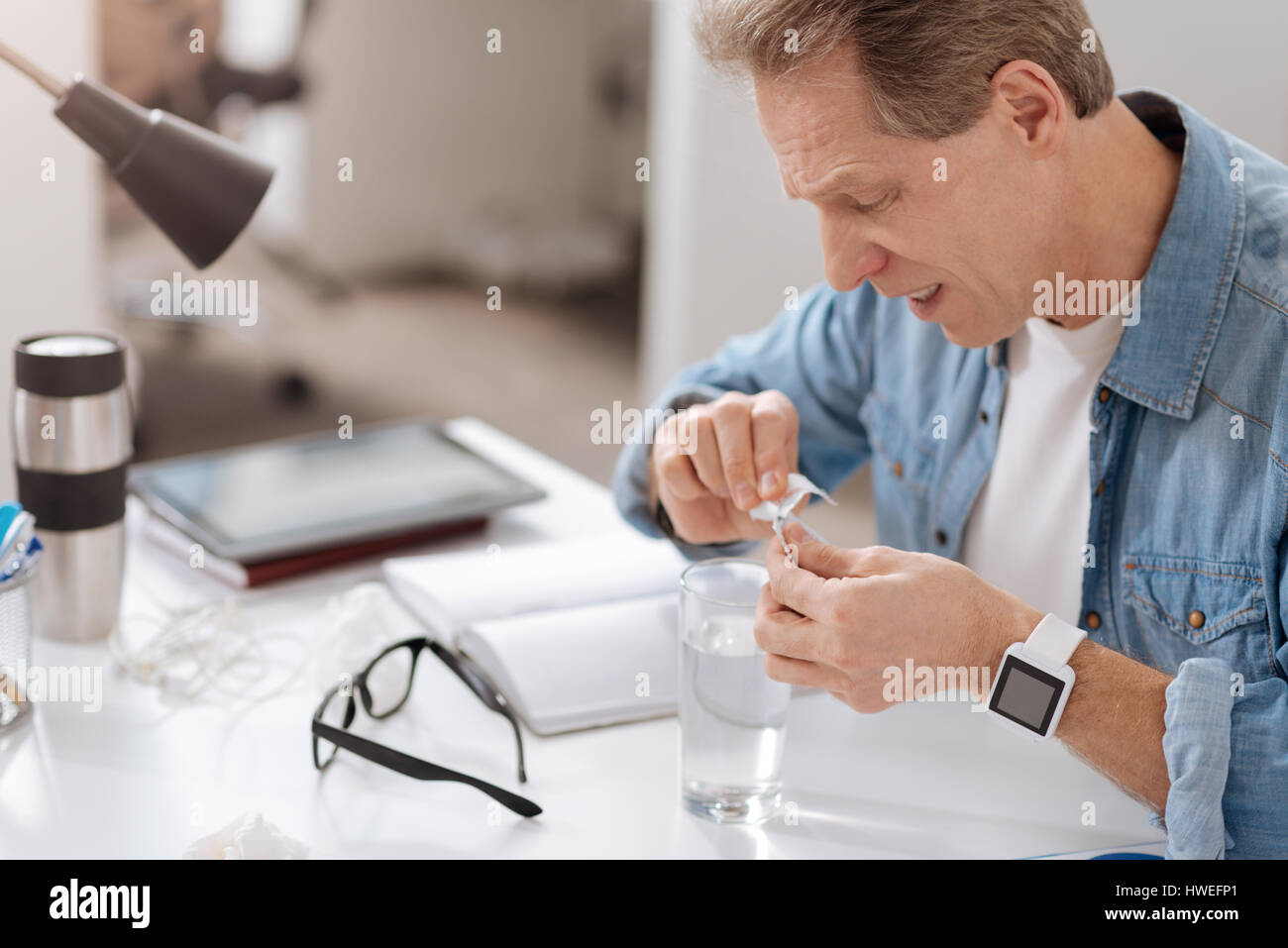 Sick elderly man preparing medicine Stock Photo - Alamy