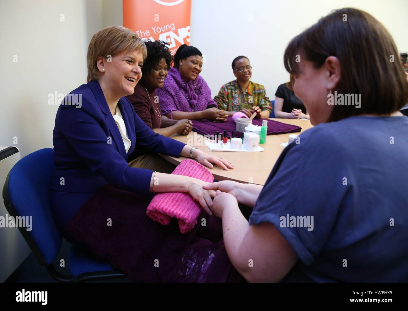First Minister Nicola Sturgeon has her hand and arm massaged by Natalie ...