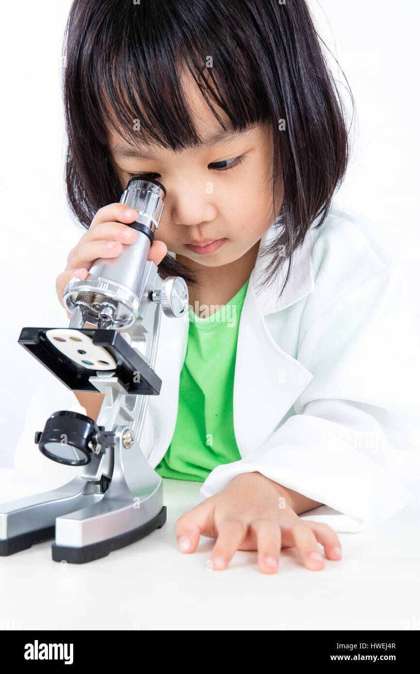 Asian Chinese Little Girl Working With Microscope in isolated white ...