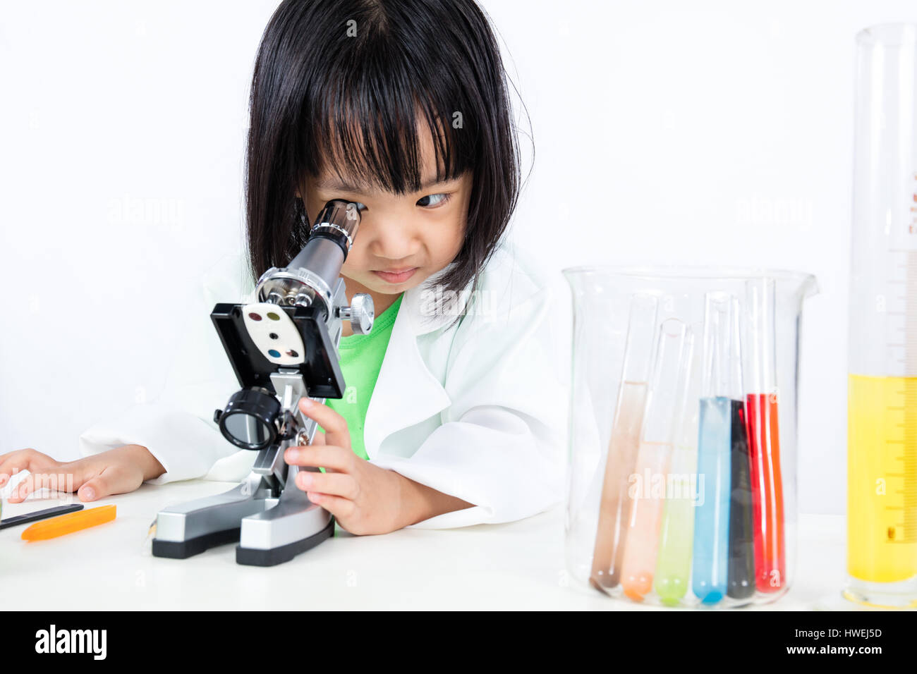 Asian Chinese Little Girl Working With Microscope in isolated white ...