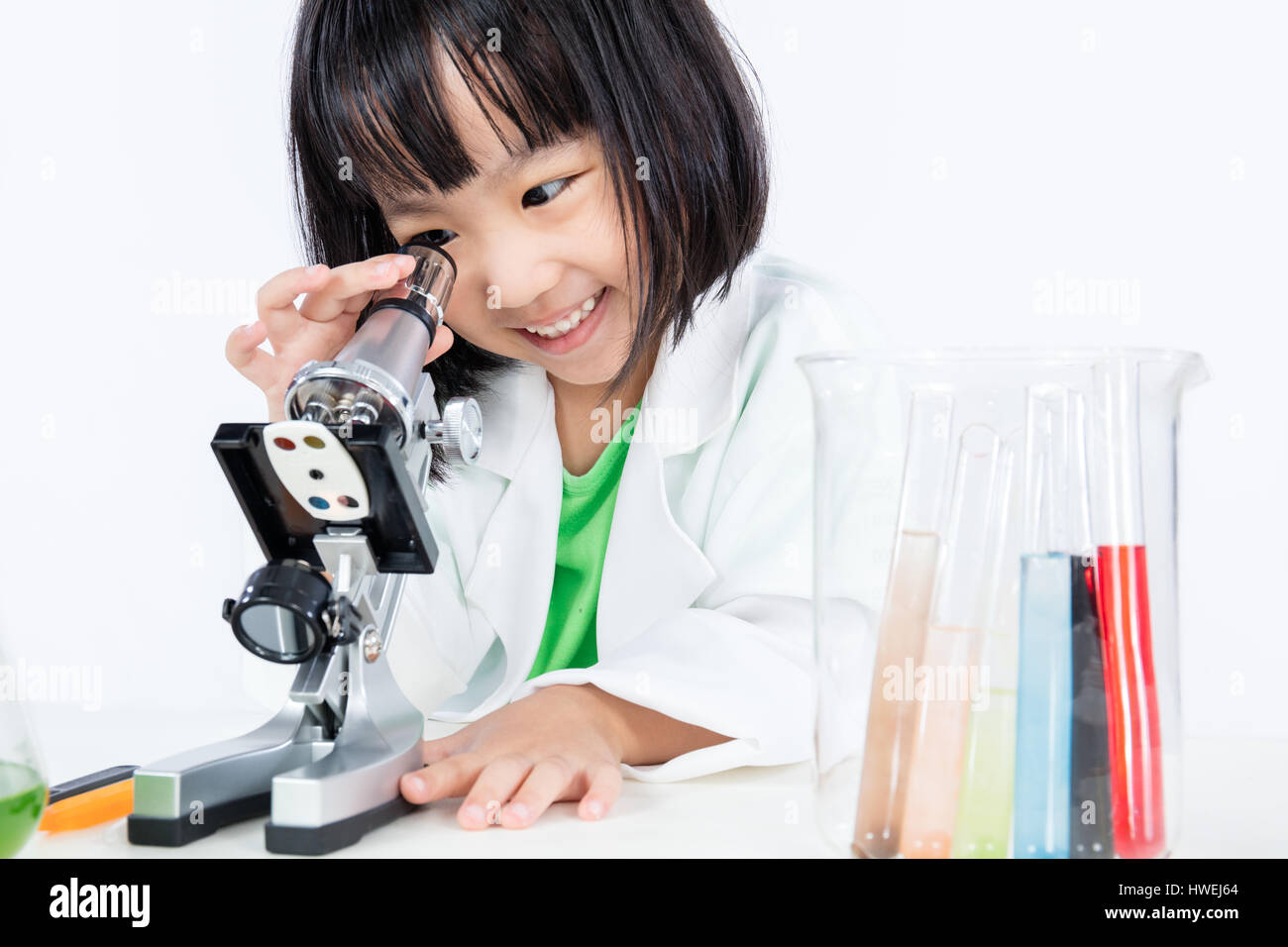 Smiling Asian Chinese Little Girl Working With Microscope in isolated ...