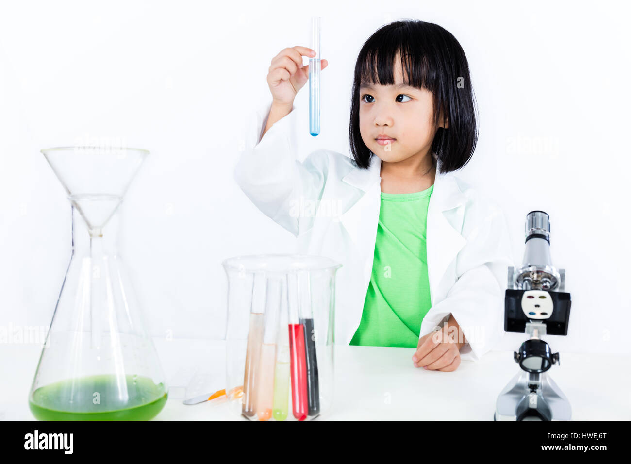 Asian Chinese Little Girl Examining Test Tube With Uniform in isolated ...