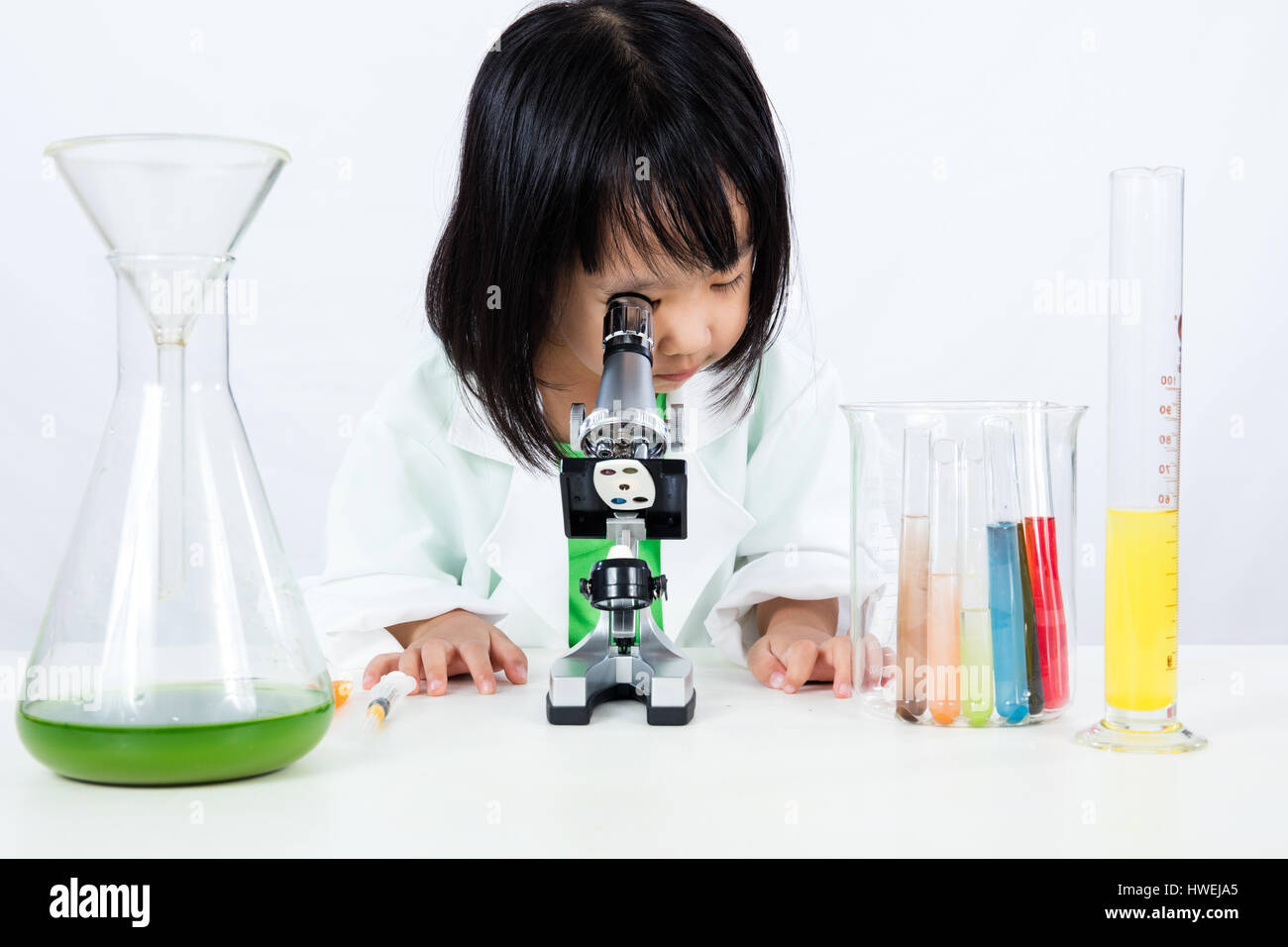 Asian Chinese Little Girl Working With Microscope in isolated white ...
