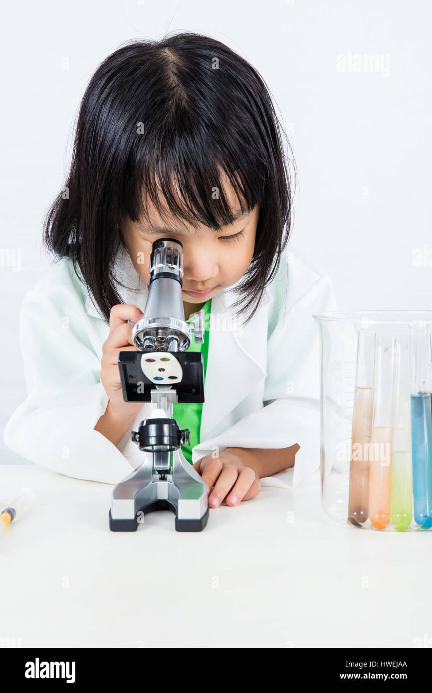 Asian Chinese Little Girl Working With Microscope in isolated white ...