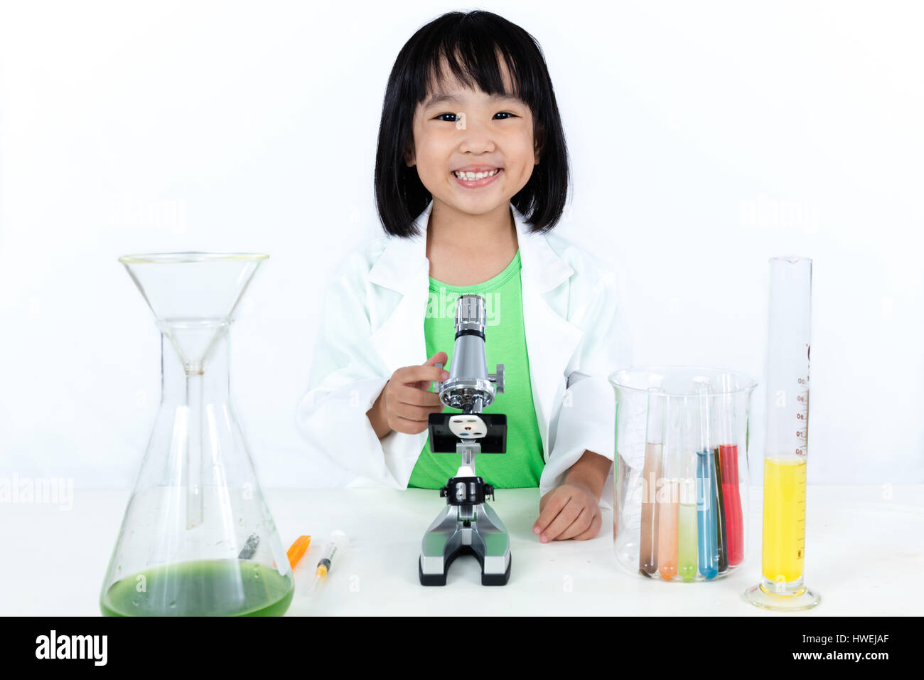 Smiling Asian Chinese Little Girl Working With Microscope in isolated ...