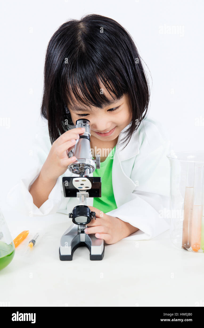 Smiling Asian Chinese Little Girl Working With Microscope in isolated ...