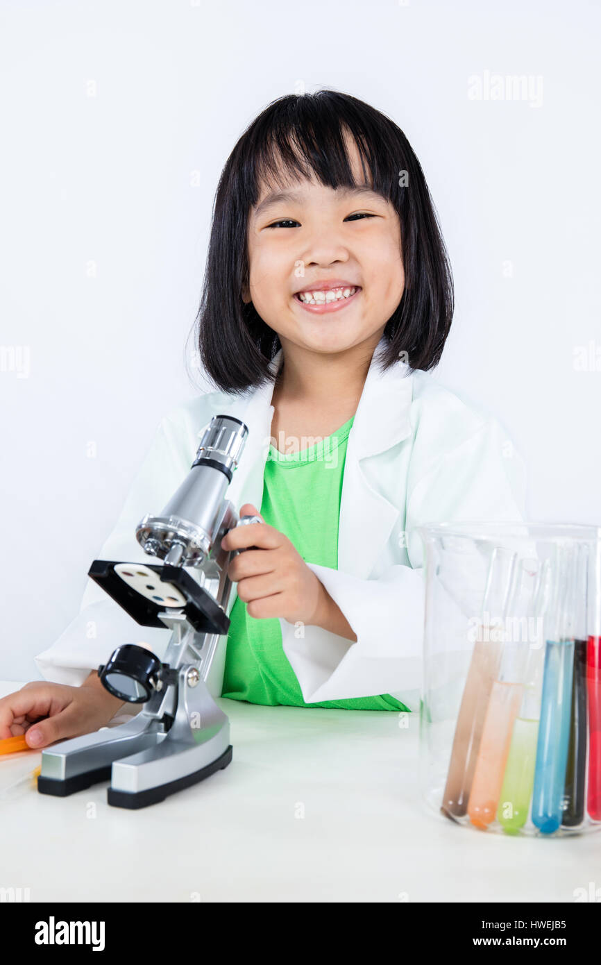 Smiling Asian Chinese Little Girl Working With Microscope in isolated ...