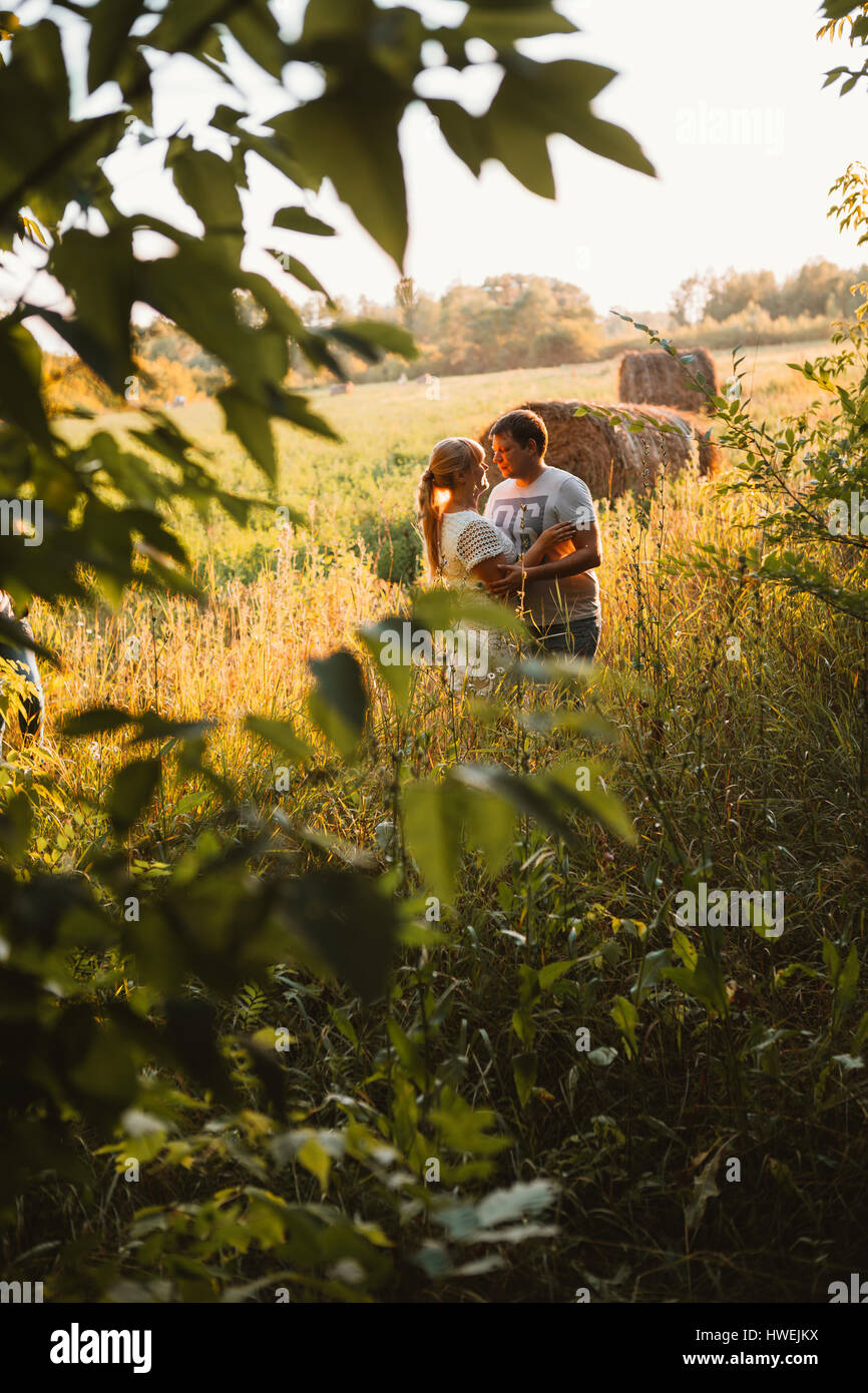 love story man and woman on the background of haystacks sun Stock Photo ...