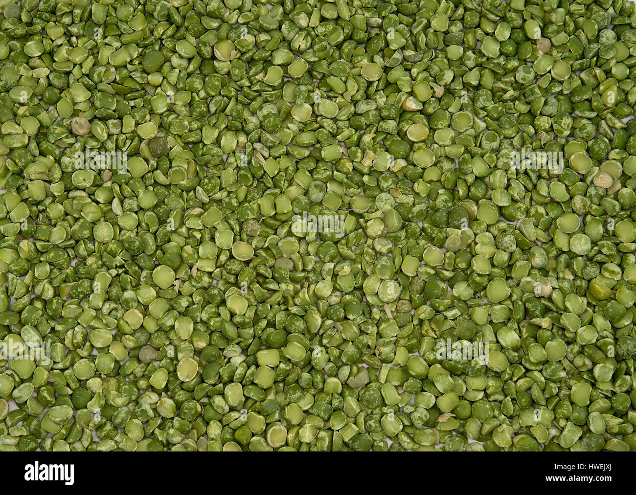 Dry split green peas texture background carpet Stock Photo - Alamy