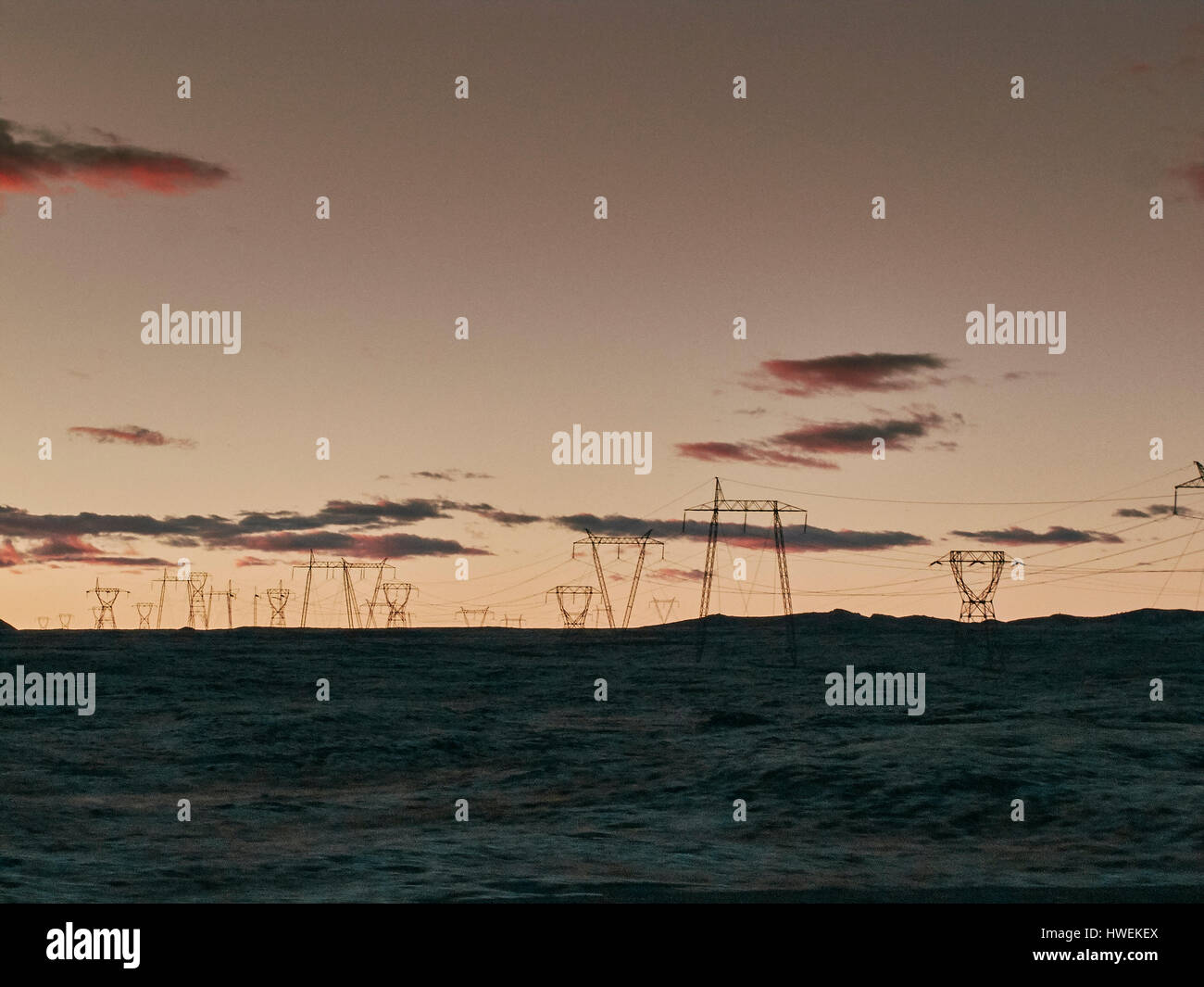 Electrical pylons in landscape at dusk, Reykjavik, Iceland Stock Photo ...