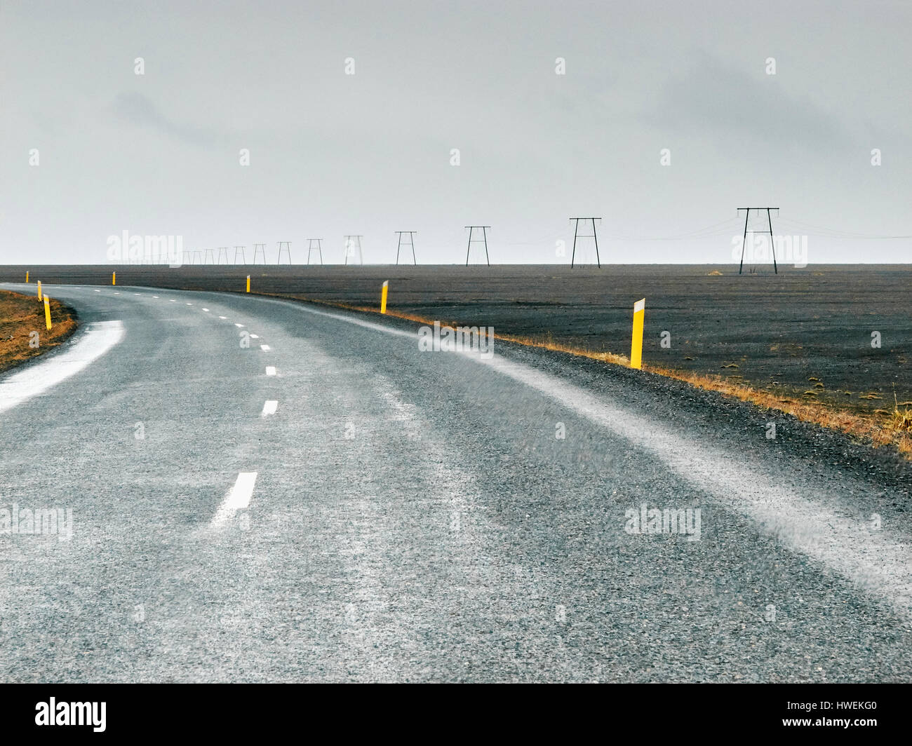 Flat landscape with pylons and rural road, Dyrholaey, Iceland Stock ...