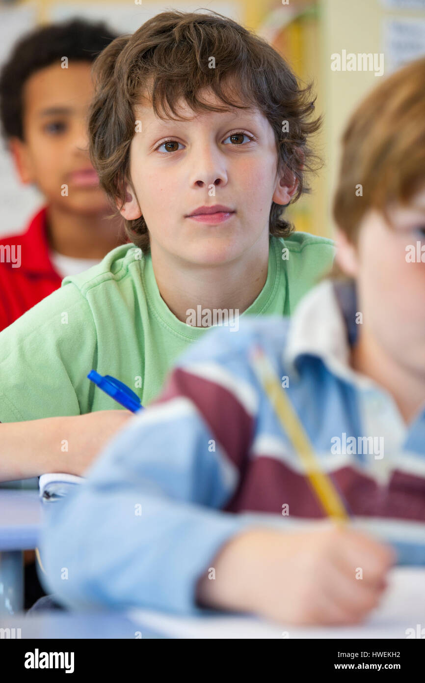 Primary schoolboys writing in classroom Stock Photo - Alamy