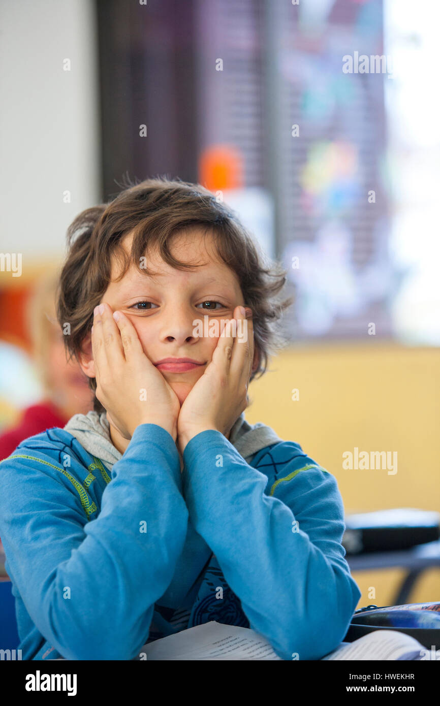 Portrait of cute primary schoolboy in classroom Stock Photo - Alamy