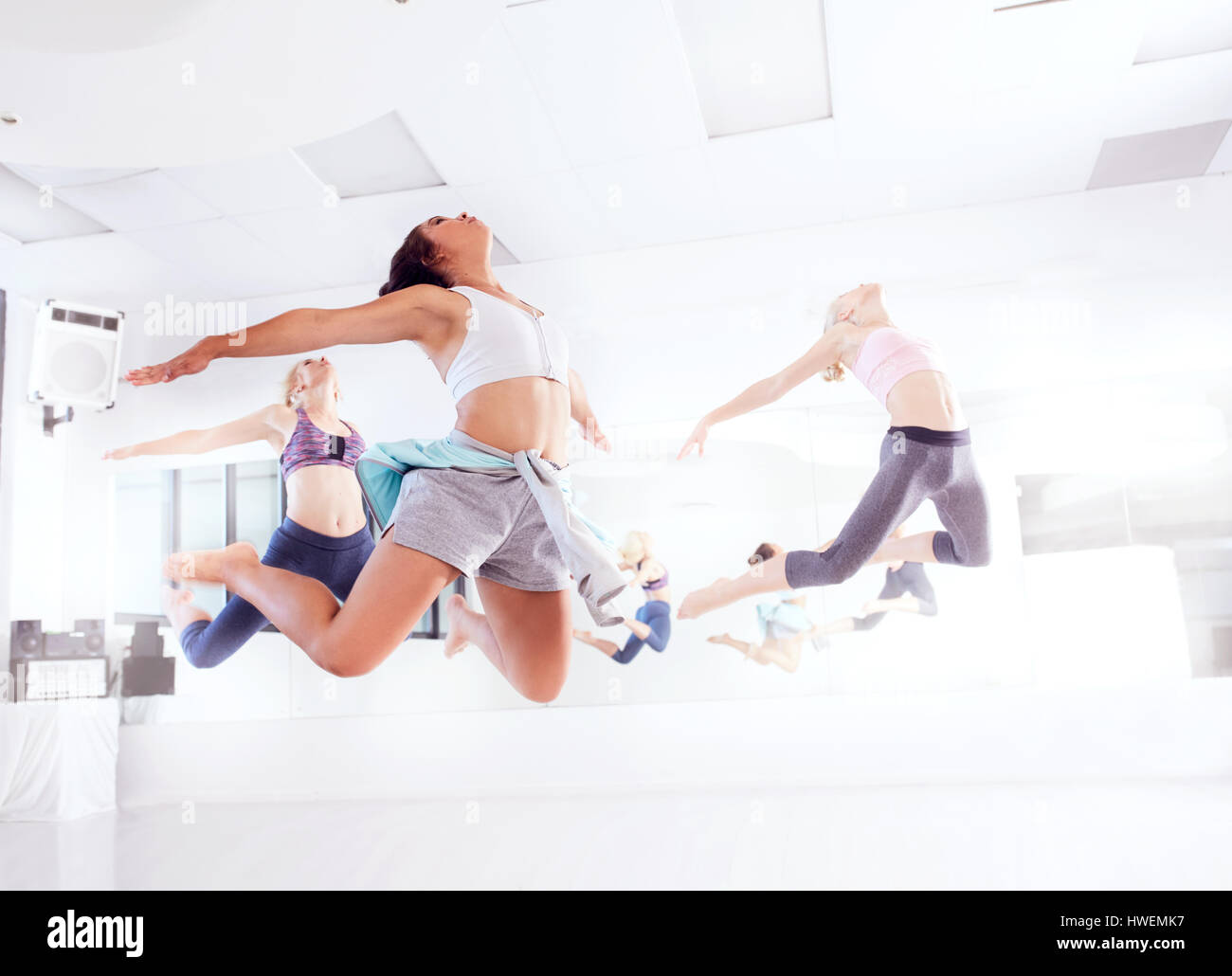 Young female ballet dancers practicing in dance studio, jumping in ...