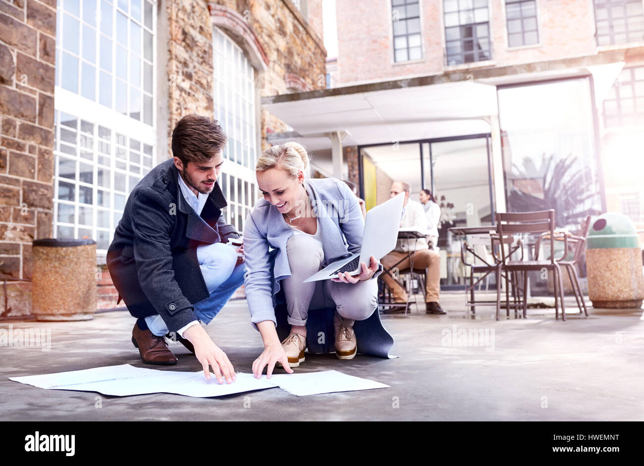 Businesswoman and man looking at paperwork on office patio floor Stock ...