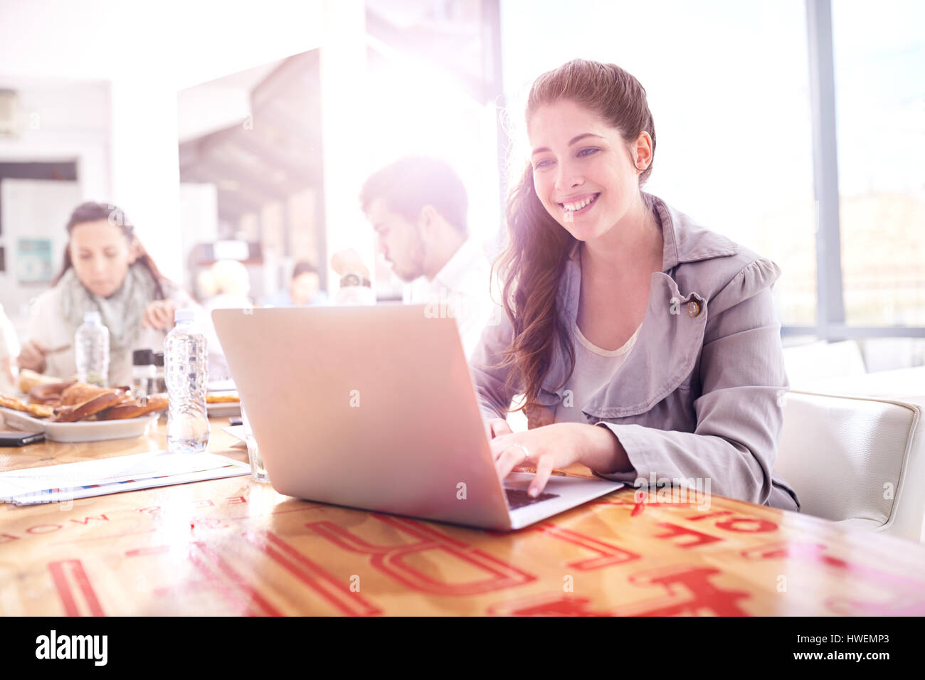 Businesswoman typing on laptop during working lunch in restaurant Stock ...