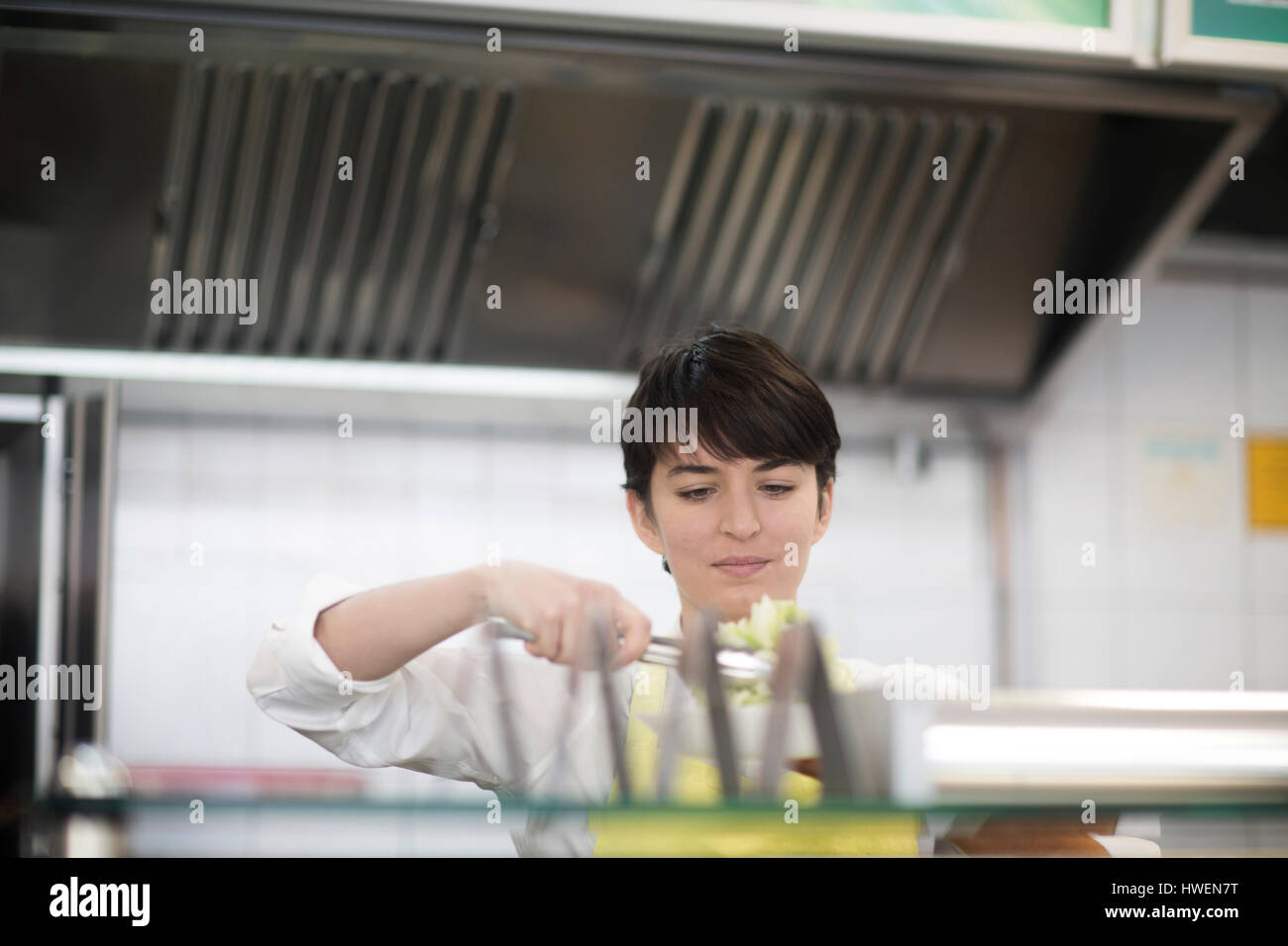 Young woman preparing food in fast food shop Stock Photo - Alamy