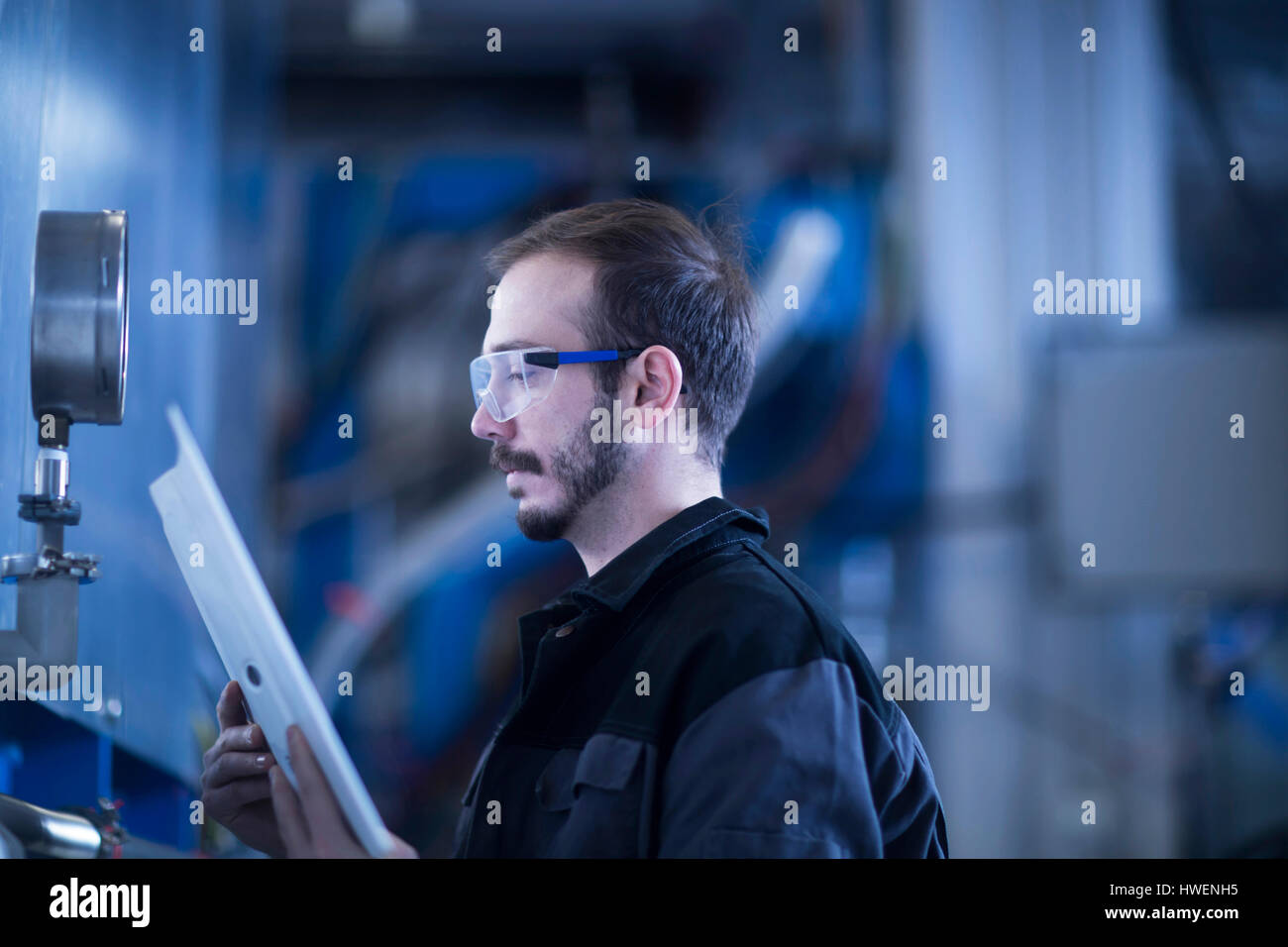 Engineer checking pressure gauge Stock Photo - Alamy