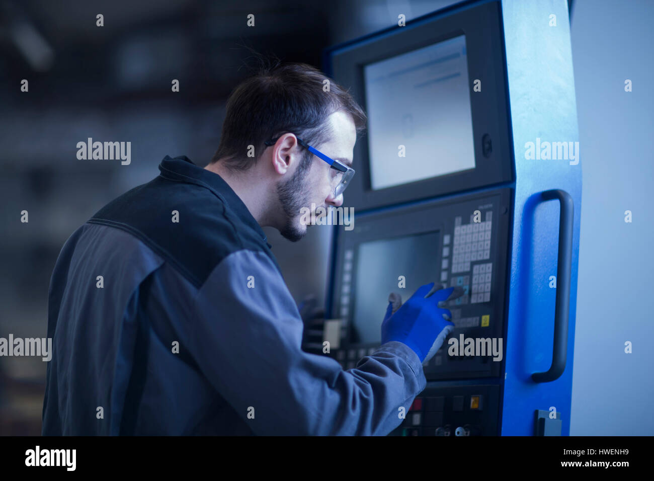 Engineer operating control panel Stock Photo - Alamy