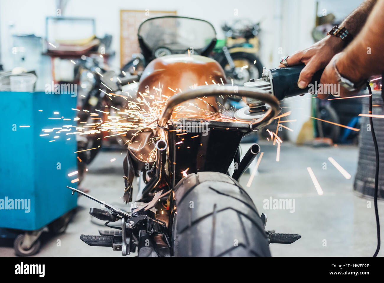 Mature man, working on motorcycle in garage Stock Photo - Alamy