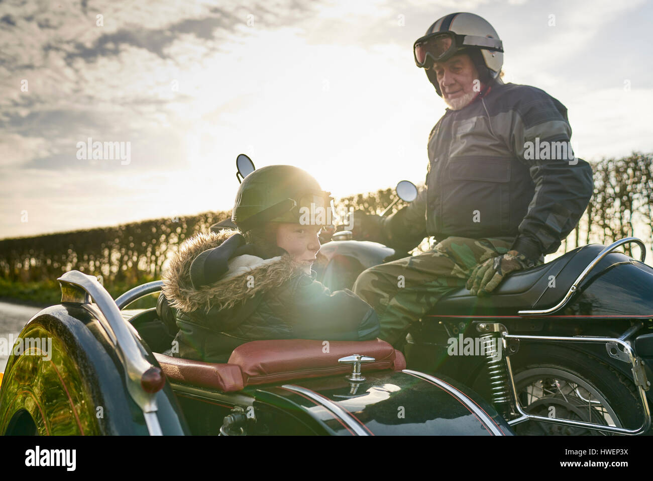 Senior man and grandson looking back from motorcycle and sidecar Stock ...