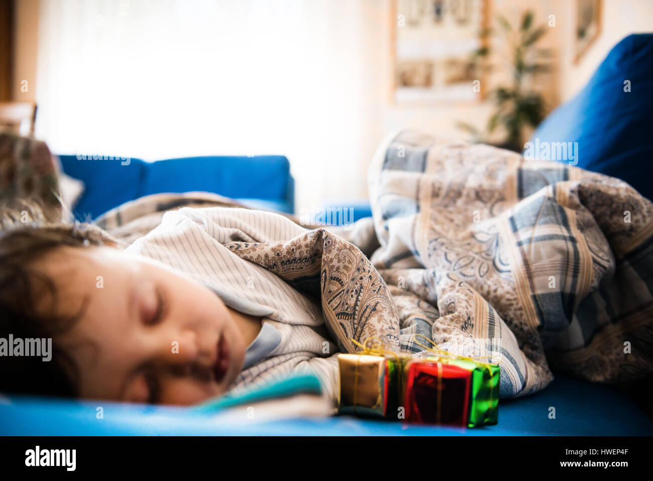 Baby boy sleeping on sofa in blanket Stock Photo - Alamy