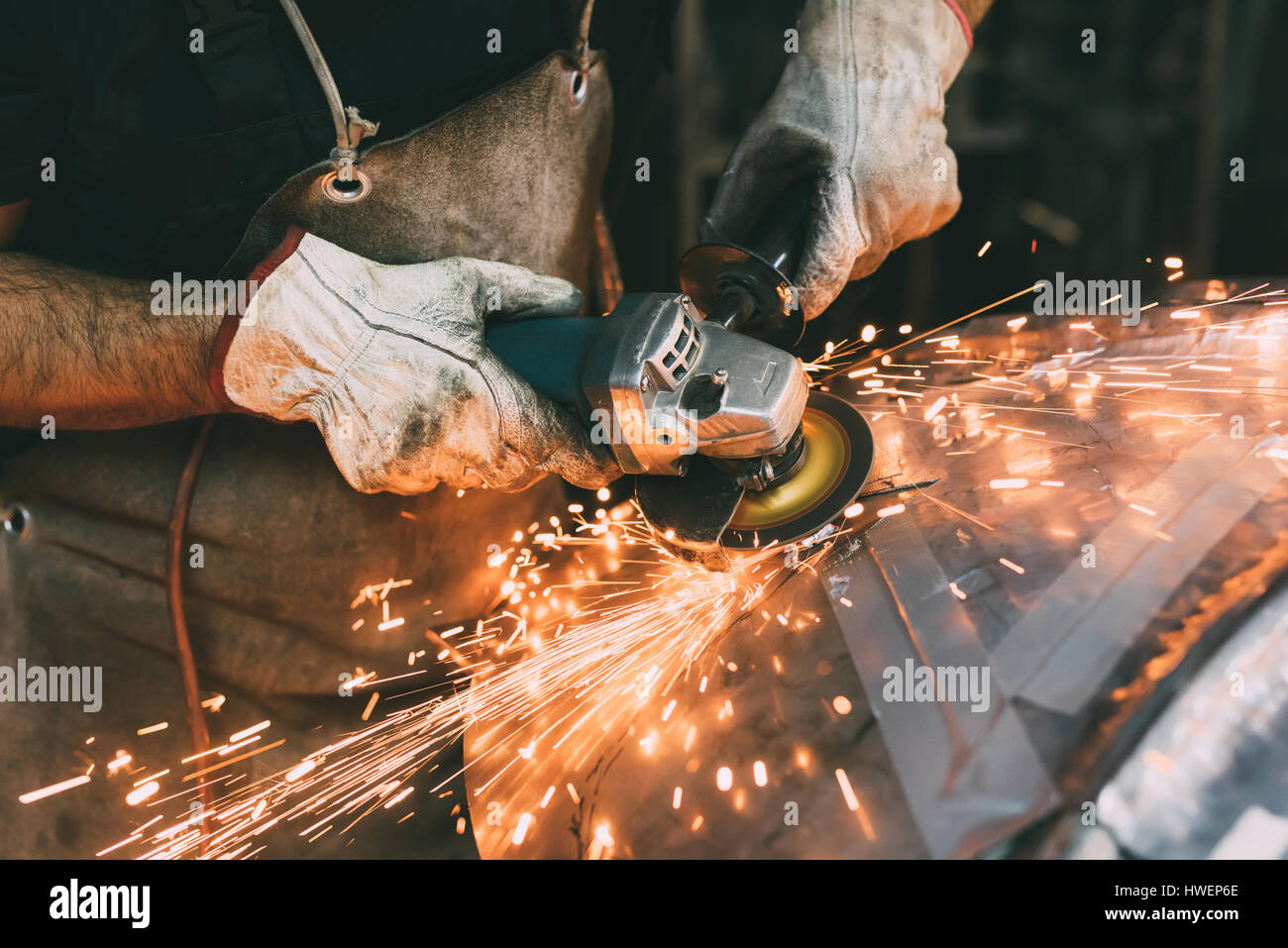 Hands of metalworker grinding copper in forge workshop Stock Photo - Alamy