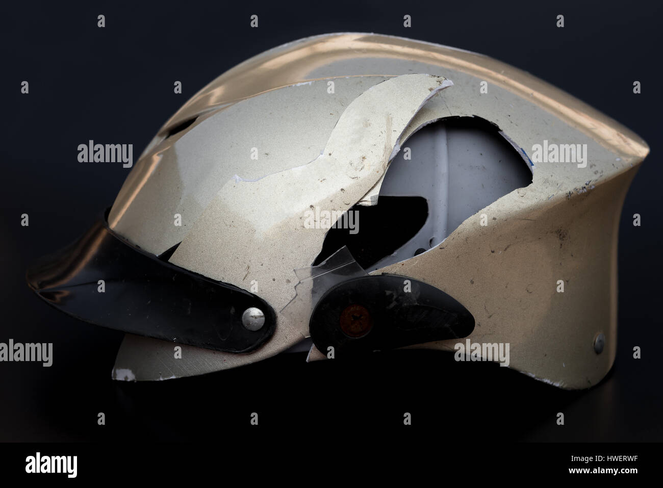 broken motobike helmet on a black background Stock Photo - Alamy