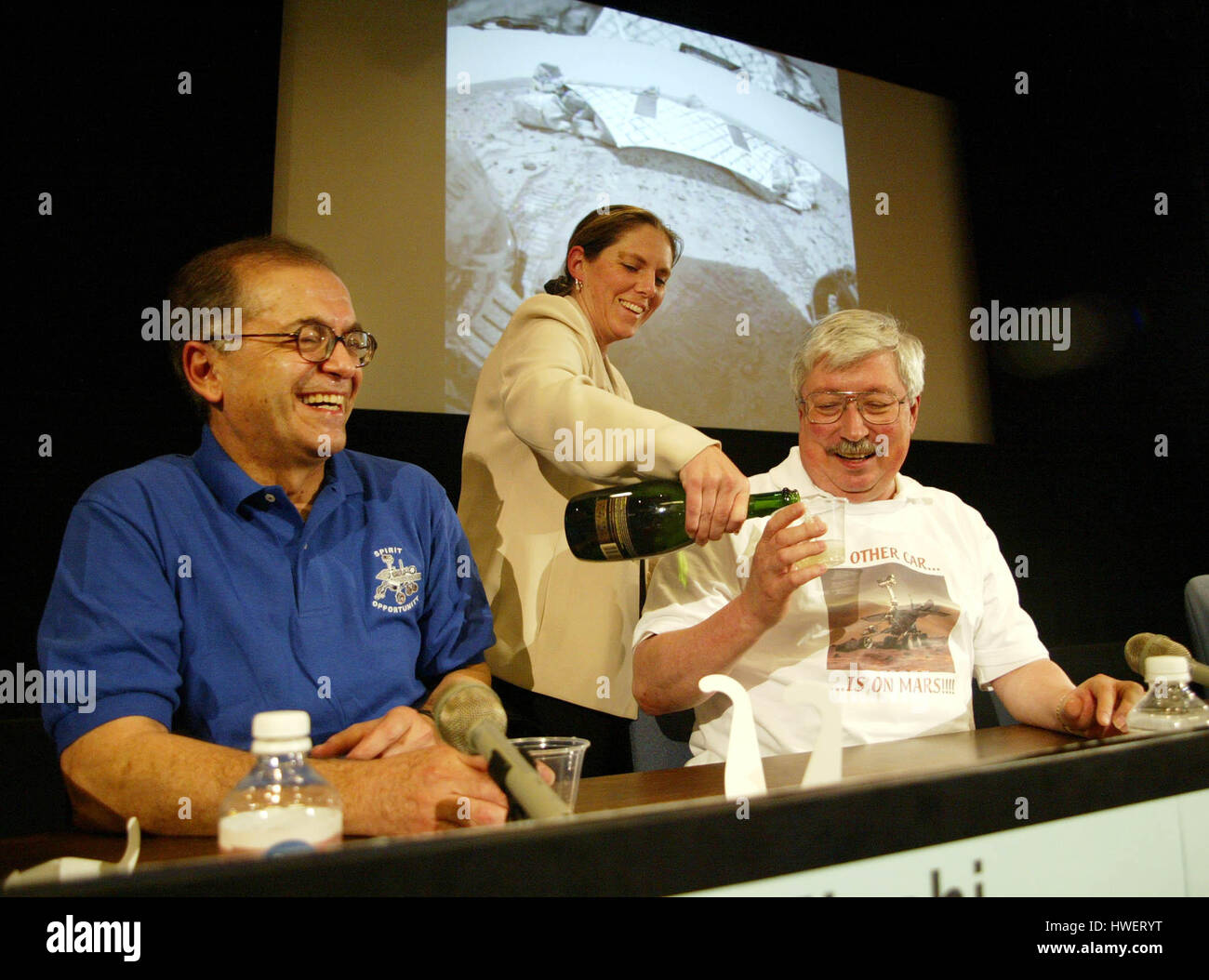 Jennifer Trosper, (C), pours champagne for Pete Theisinger, (R) and ...