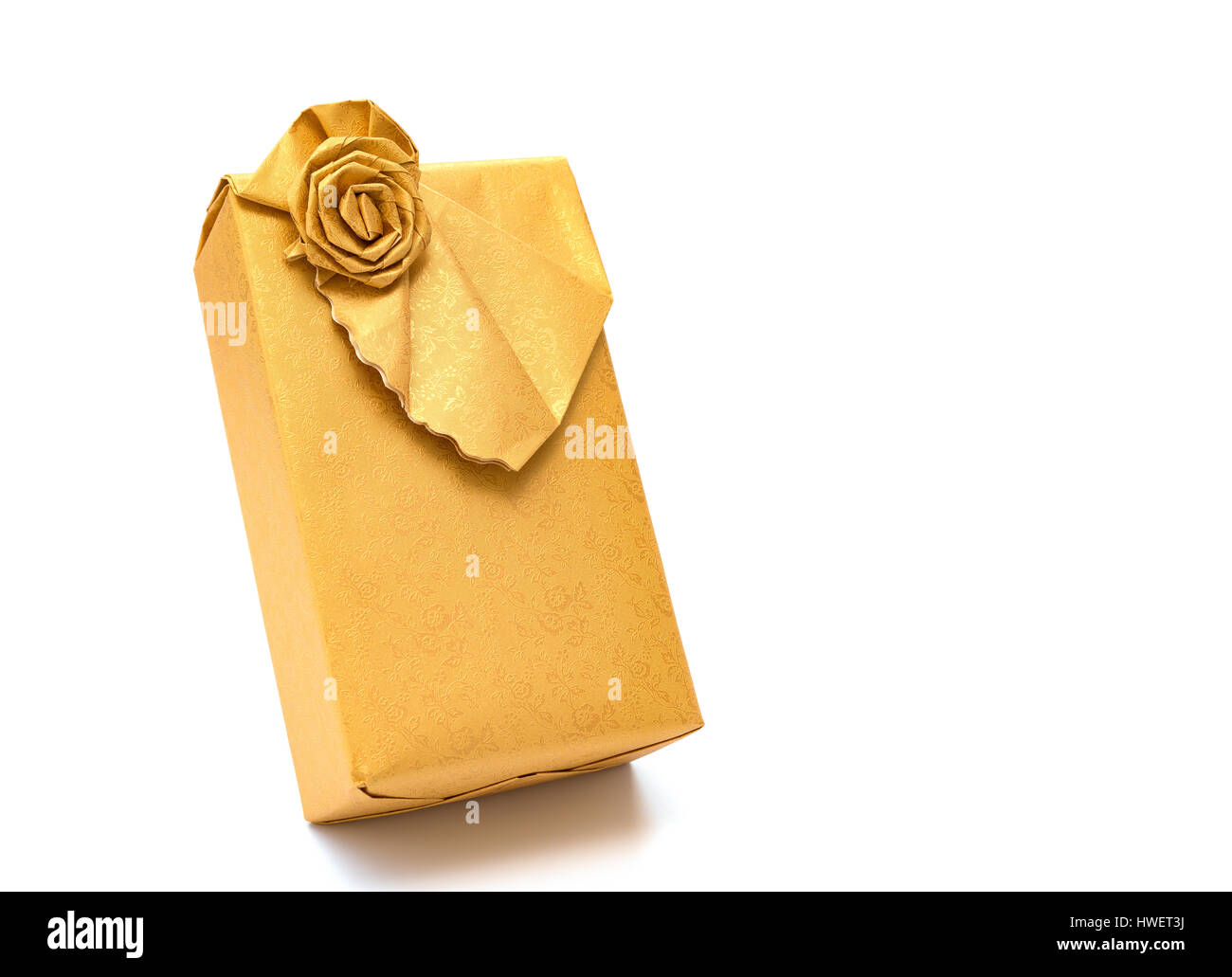 wrapped golden present box on white background Stock Photo - Alamy