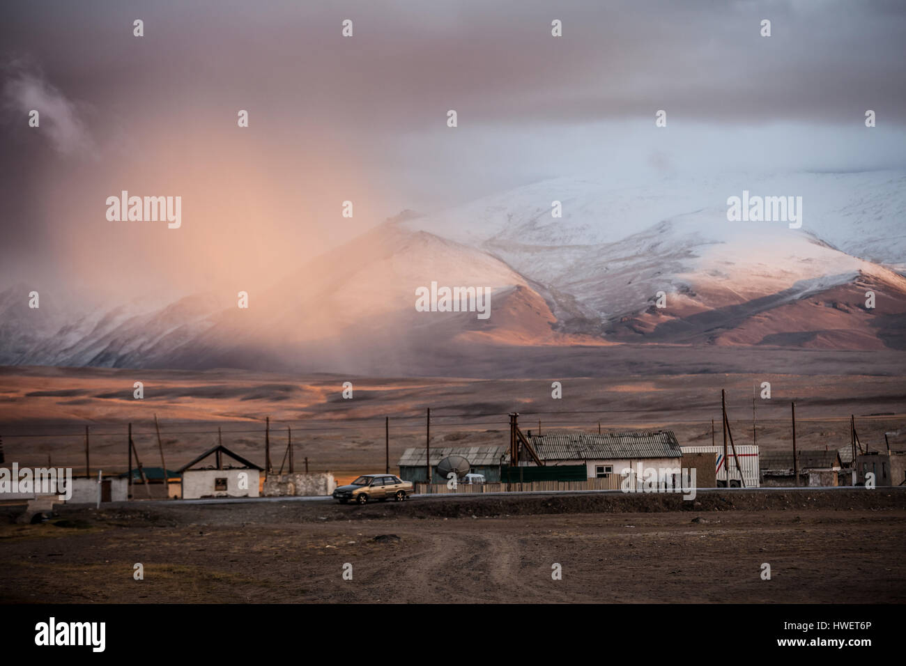 Tajikistan,a view of a landscape of mountain and a village at sunset ...