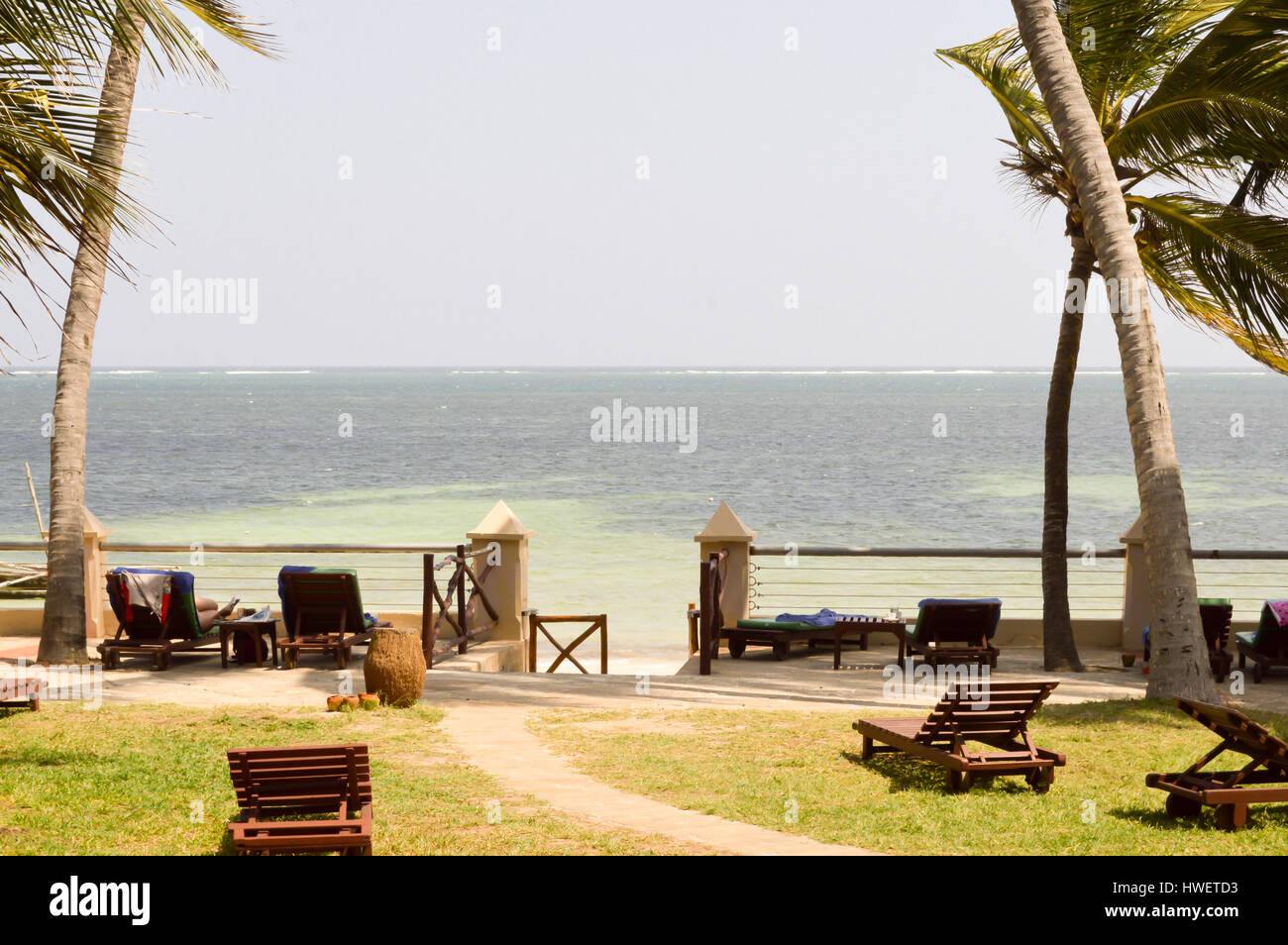 Terrace with empty sunbeds and a view of the Indian Ocean in Kenya ...