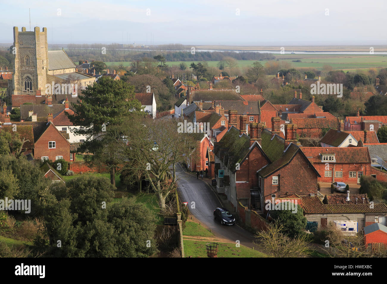 Orford Ness shingle spit view over village rooftops, Orford, Suffolk ...