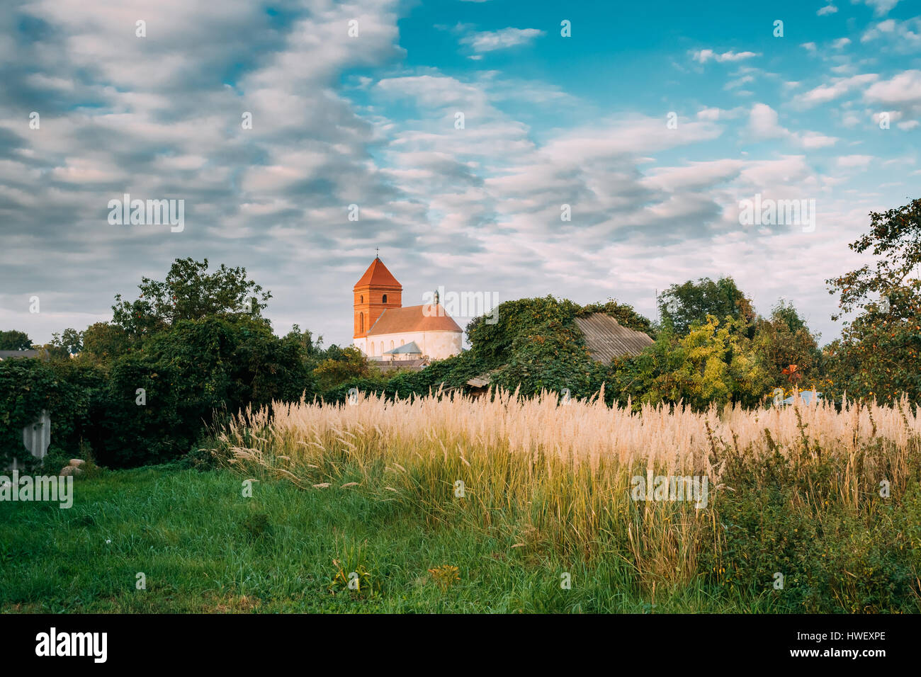 Mir, Belarus. Landscape Of Village Houses And Saint Nicolas Roman ...
