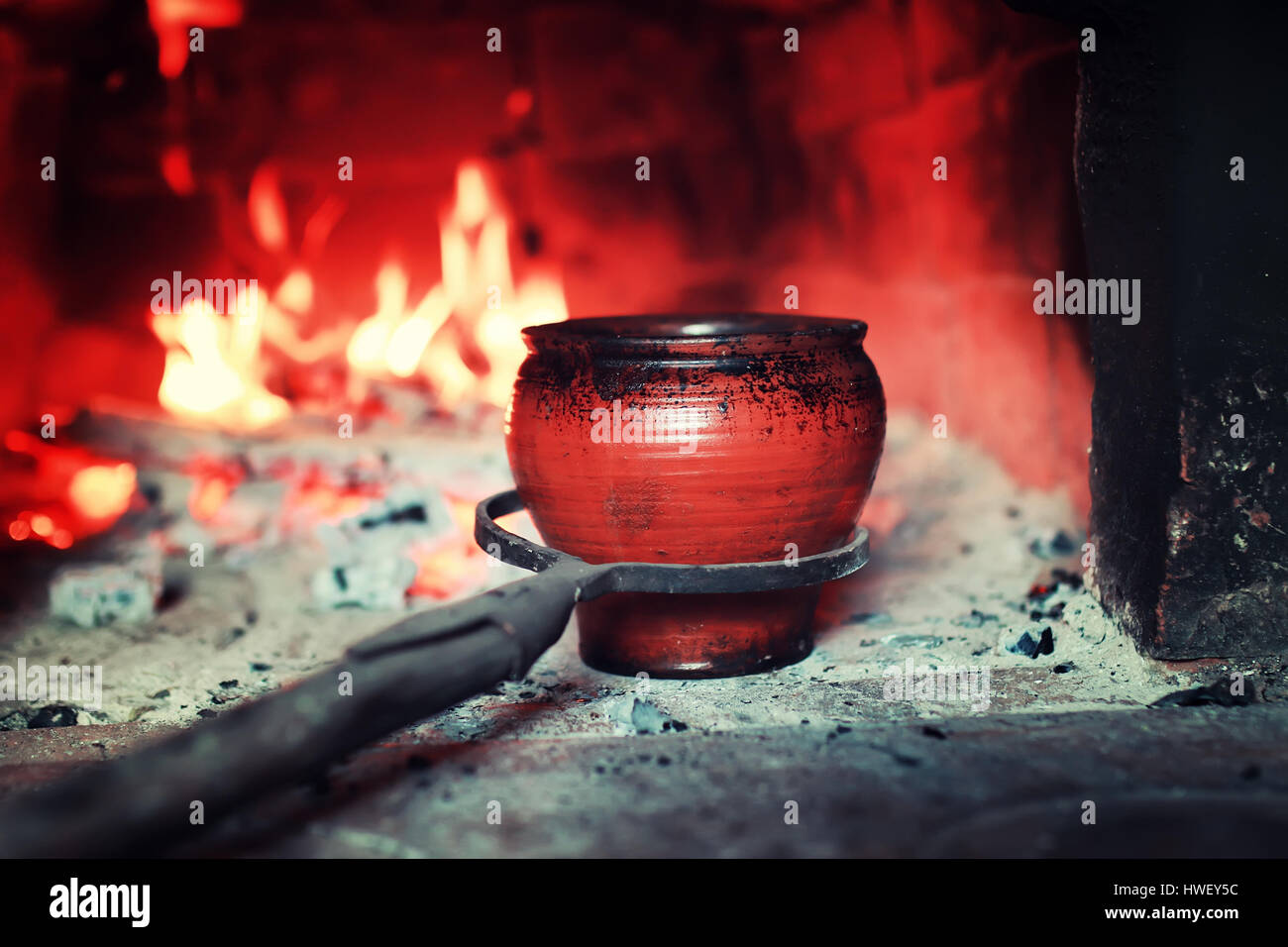 pot in the oven and oven fork Stock Photo - Alamy