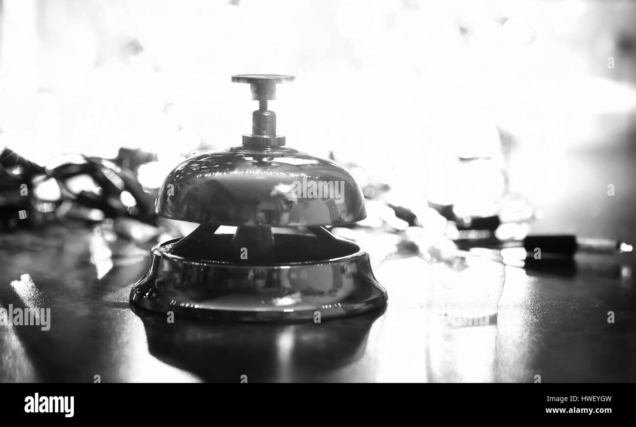 reception bell on the table and shining garland background Stock Photo ...