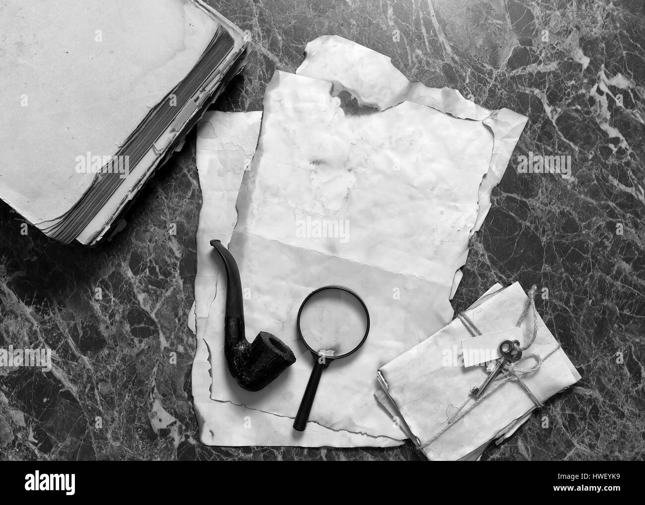 papers and book on detective work table with tools Stock Photo - Alamy