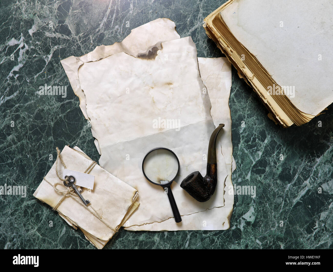 retro papers and book on detective work table with tools Stock Photo ...