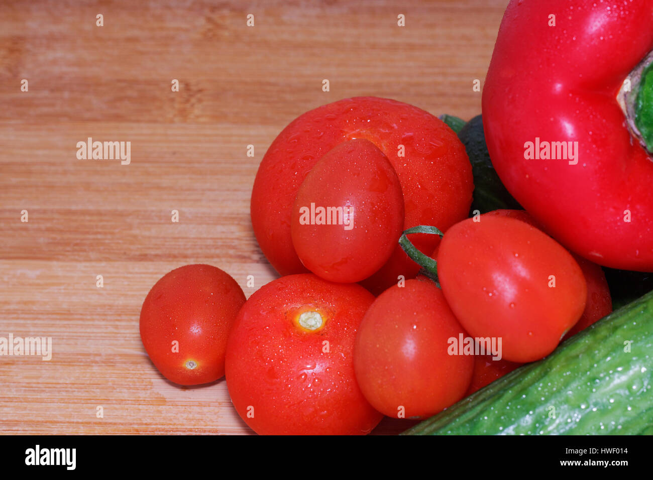 Paprika, tomatoes, cucumber fresh and washed on a wooden board Stock ...