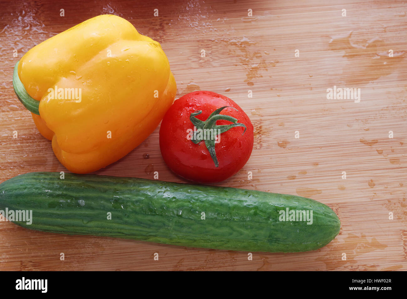 Paprika, tomatoes, cucumber fresh and washed on a wooden board Stock ...