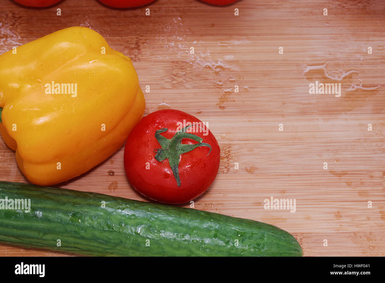Paprika, tomatoes, cucumber fresh and washed on a wooden board Stock ...