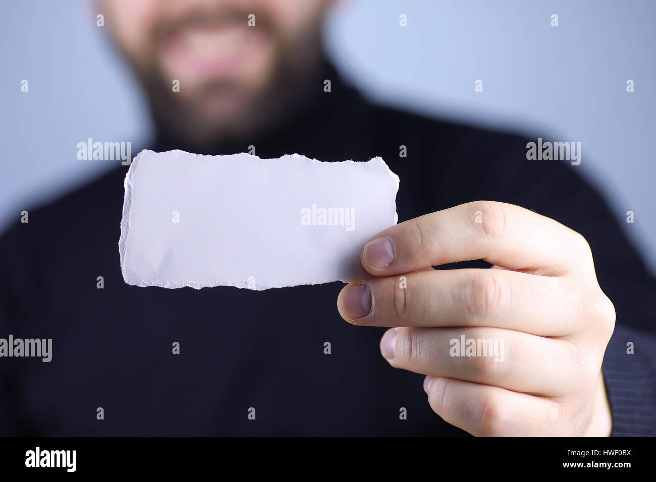 small white piece of paper in his hand man Stock Photo - Alamy