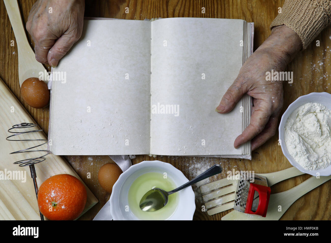 Open recipe book in the hands of an elderly woman Stock Photo - Alamy