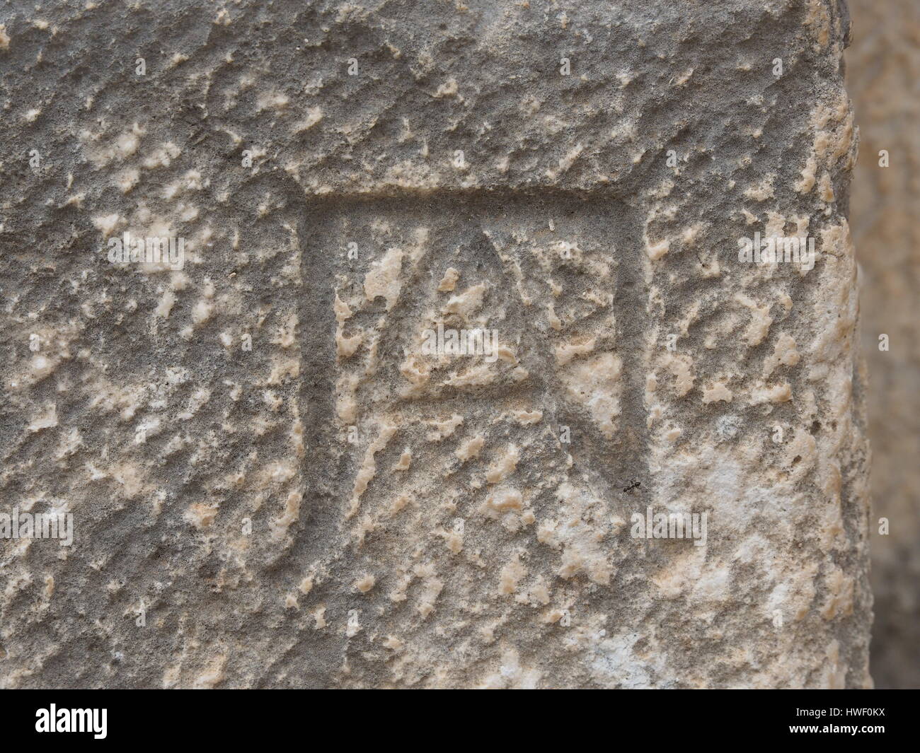 SYMBOL AND LETTERS CARVED INTO STONE FACE IN STONE AT MYRA, ANCIENT ...